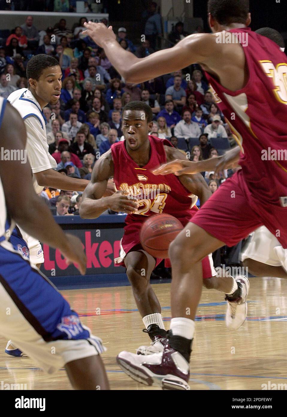 Winthrop's DeAndre Adams (24) makes a fast break with teammate Billy ...