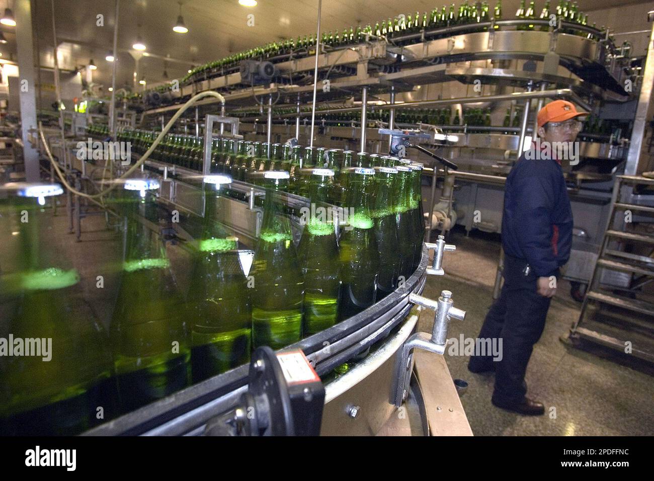 A Chinese worker stands near a packaging line for Hapi beer at the ...
