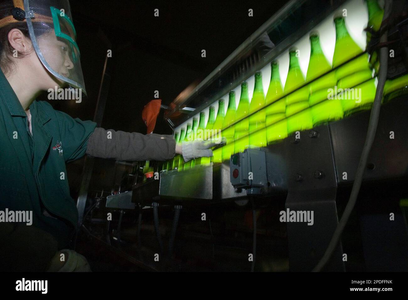 A Chinese worker inspects bottles of beer during packaging at the ...