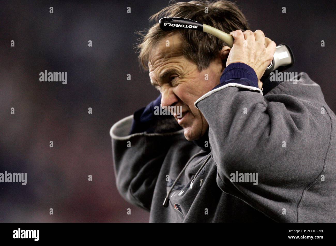 New England Patriots head coach Bill Belichick adjusts his headset ...