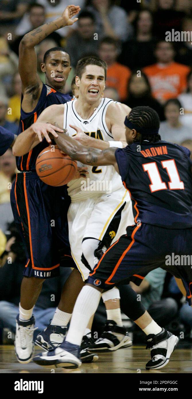 Iowa's Jeff Horner, center, looks to drive between Illinois' Jamar ...