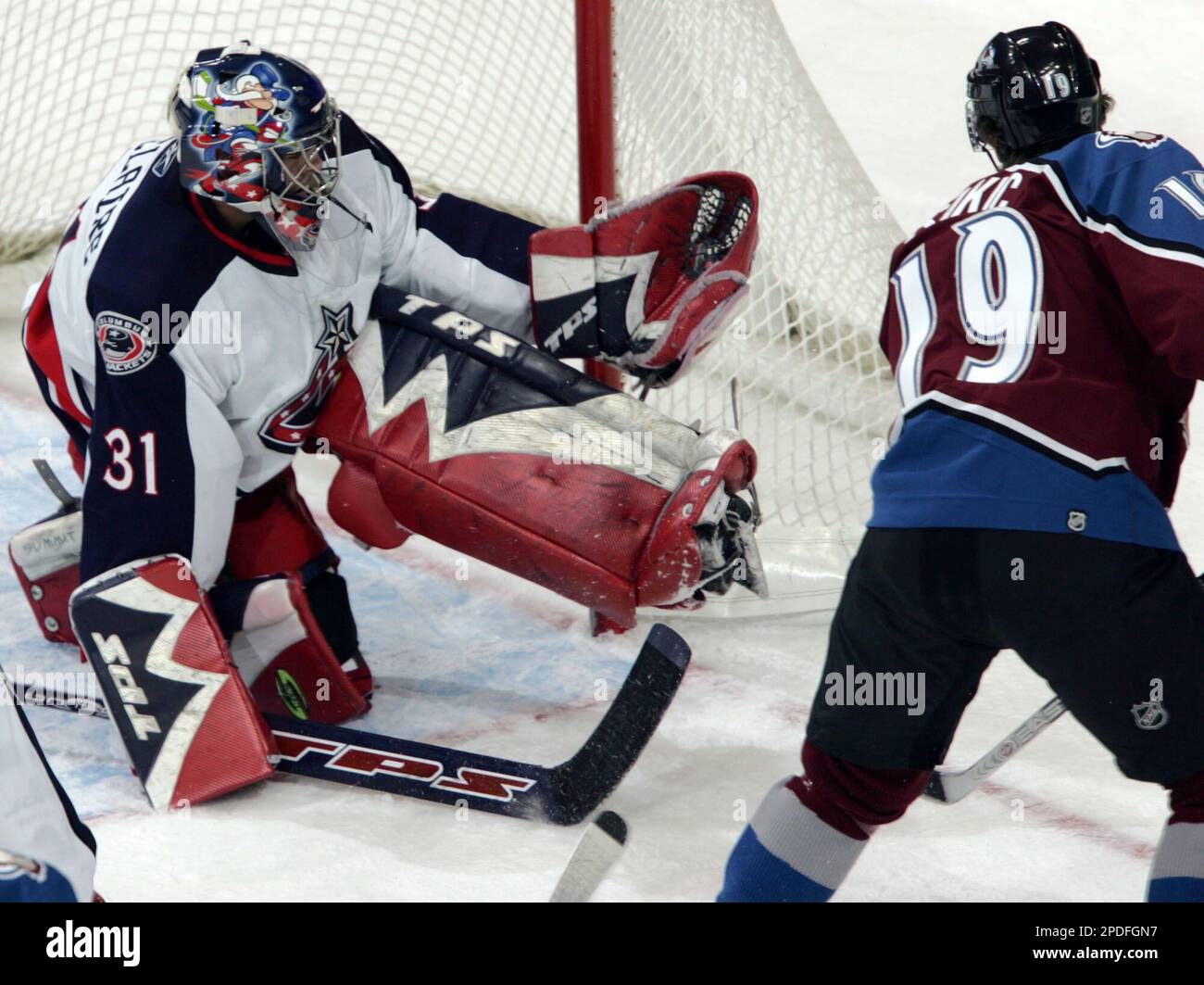 Columbus Blue Jackets goalie Pascal Leclaire, left, stops a shot off ...