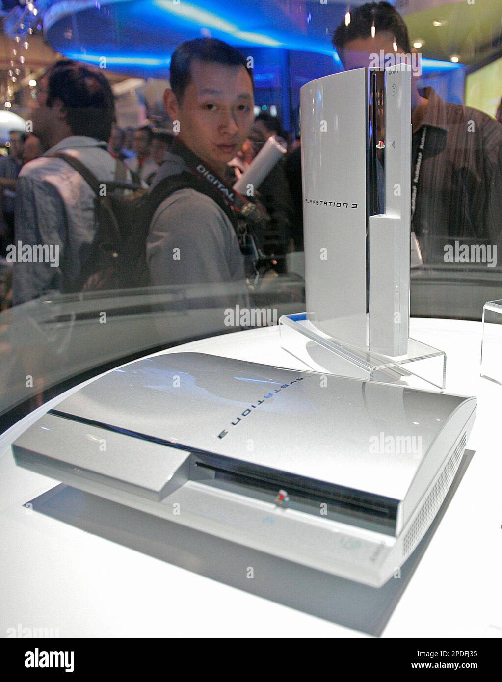 Show attendees look at new Sony Playstation 3 showcased at the Consumer ...