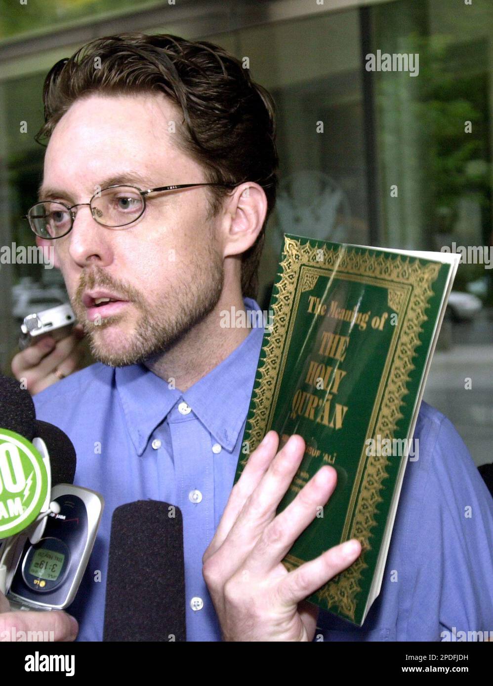 **FILE**Brandon Mayfield holds up a book titled "The Meanining of the ...