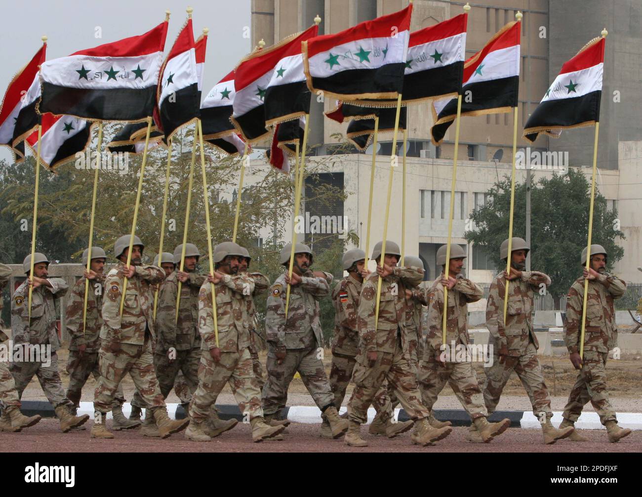 Iraqi soldiers march with the Iraqi national flag during the 85th ...