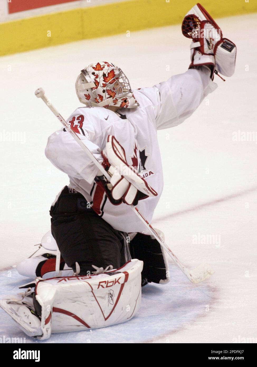 Team Canada's Justin Pogge makes a glove-save in the first period ...