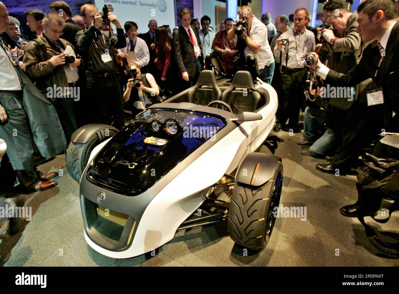 Members of the media examine the Volkswagen GX3 concept car Wednesday ...