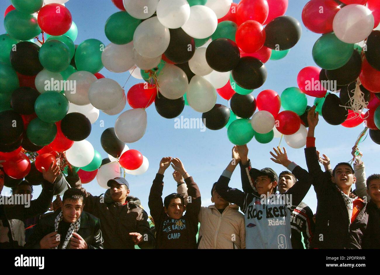 Palestinian youths release balloons in the colors of the Palestinian ...