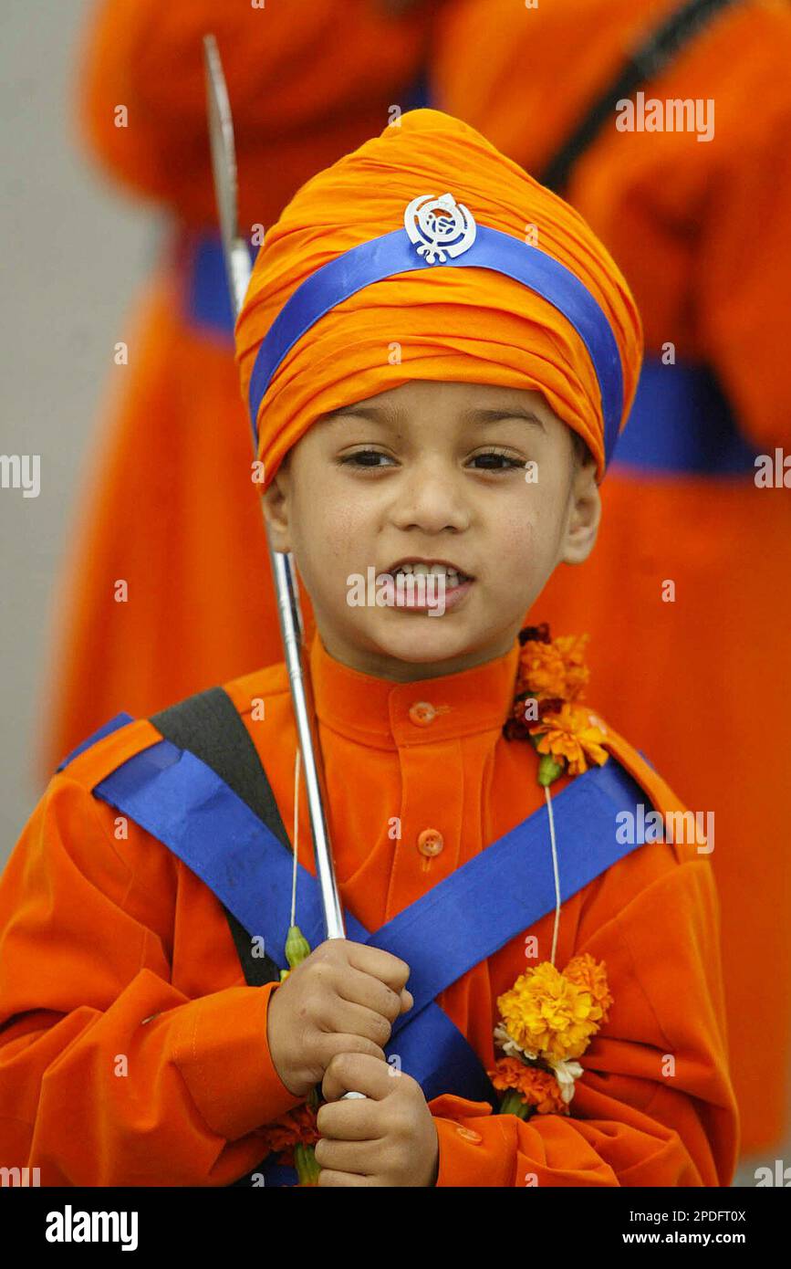 A Sikh child walks in a procession to celebrate the birth anniversary ...
