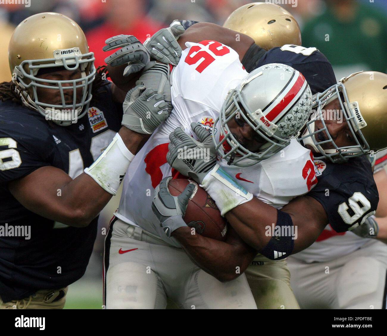 Ohio State's Antonio Pittman is tackled by Notre Dame defenders Corey ...