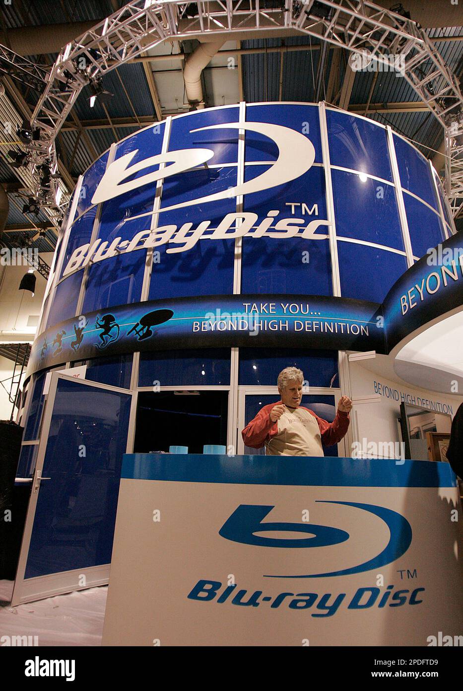 Sherman Stephens installs signs at Panasonic's Blu-ray Disc booth at ...