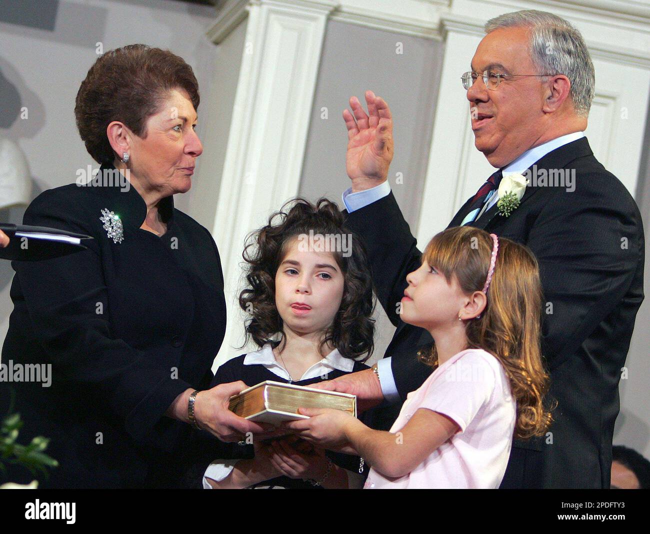Boston Mayor Thomas Menino, right, takes the oath of office as his wife ...