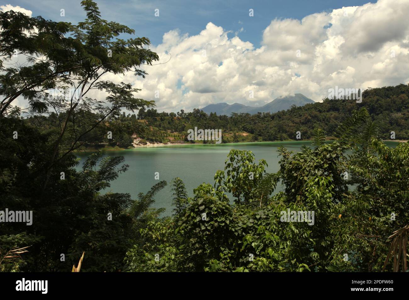 A view of Lake Linow, a volcanic lake, in a background of the twin ...