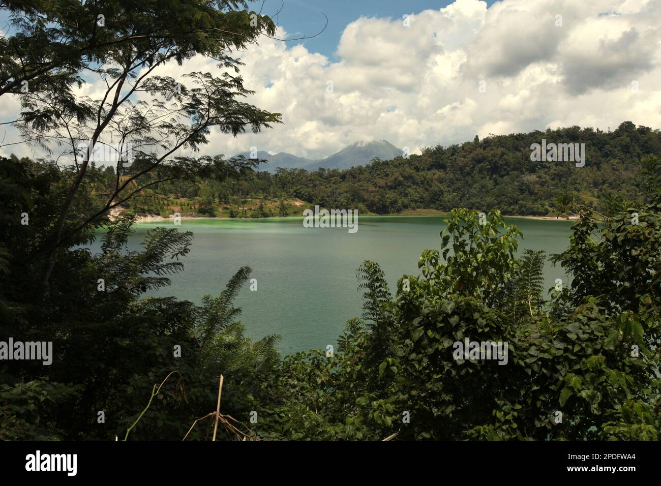 A view of Lake Linow, a volcanic lake, in a background of the twin ...