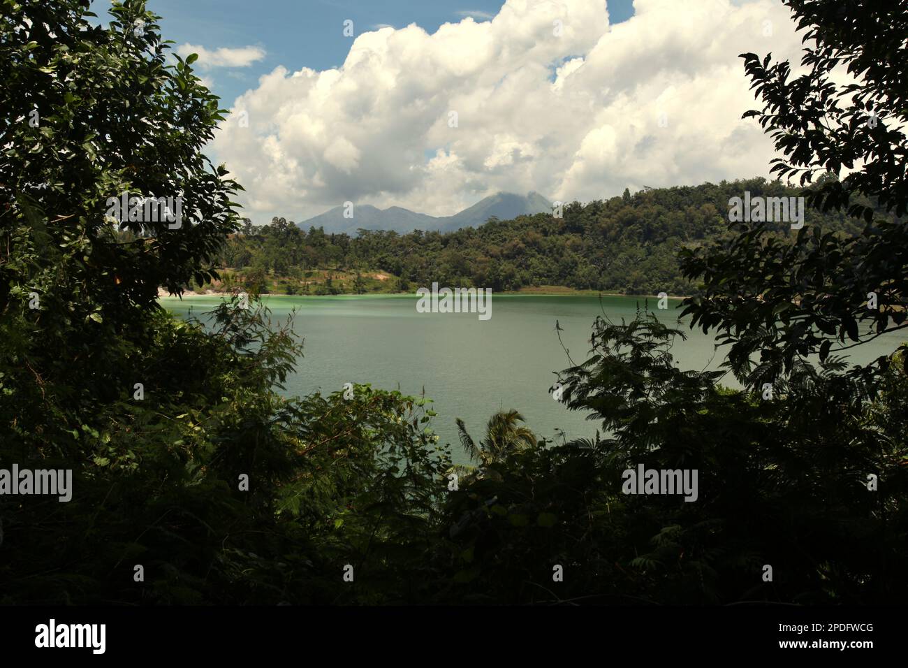 A view of Lake Linow, a volcanic lake, in a background of the twin ...