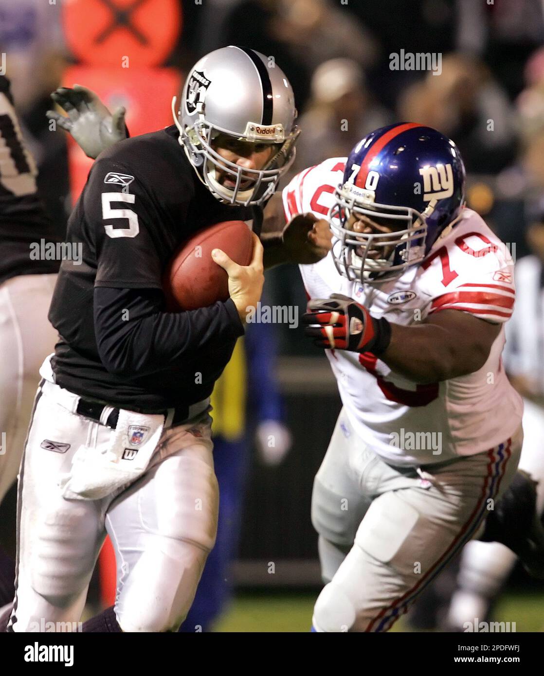 New York Giants' Kendrick Clancy, right, reaches to sack Oakland ...