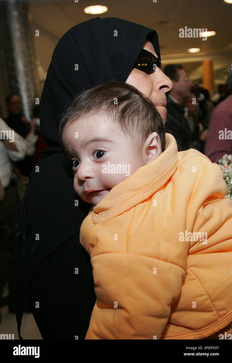 Baby Noor clings to her grandmother as they arrive at Hartsfield ...