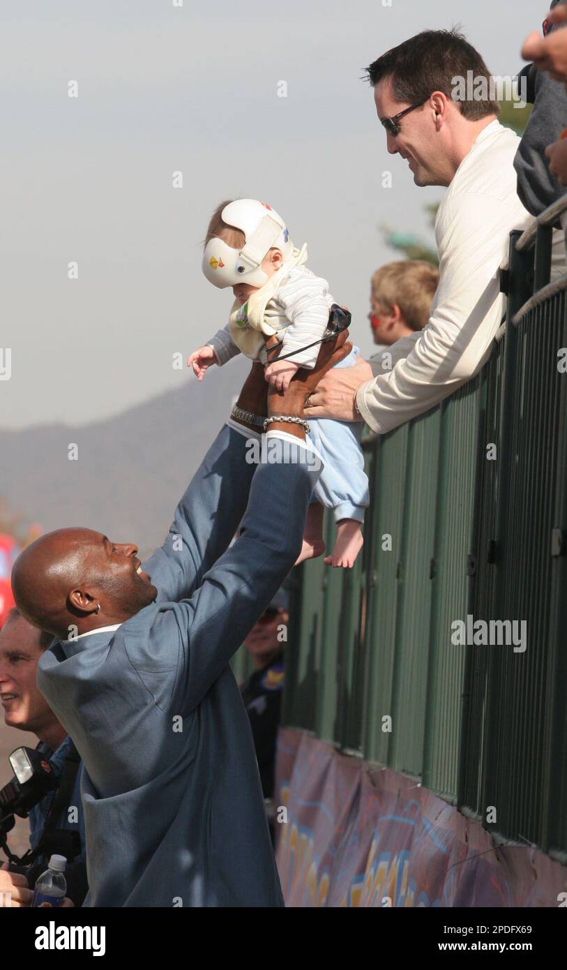 Fiesta Bowl Parade Grand Marshal Jerry Rice, left, hands seven-month ...