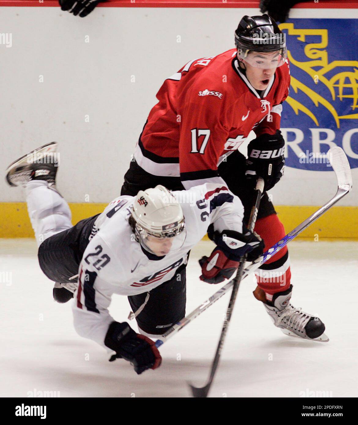 Team USA's Nathan Gerbe (20) is up-ended by Team Switzerland's Dario ...