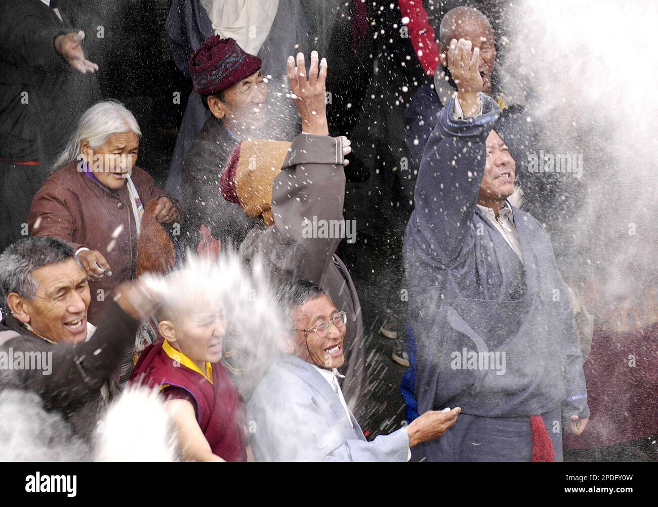 ** FILE ** In a file photo Tibetans throw tsampa, or barley flour, in ...