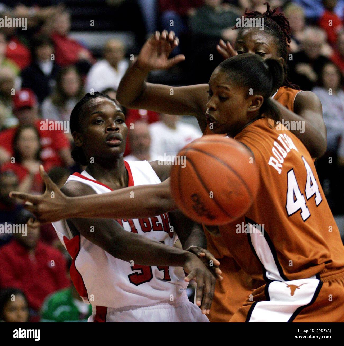 Rutgers' Michelle Campbell (34) passes the ball around Texas' Tiffany ...