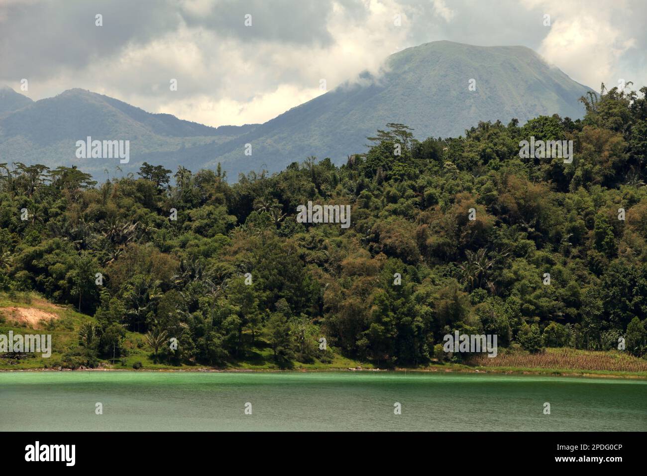 A view of Lake Linow, a volcanic lake, in a background of the twin ...