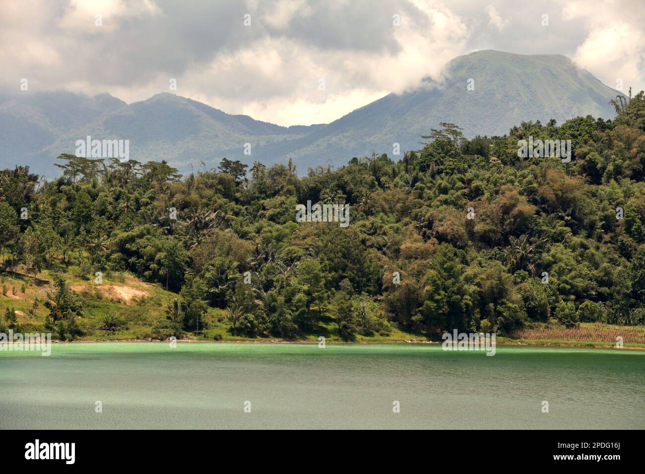 A view of Lake Linow, a volcanic lake, in a background of the twin ...