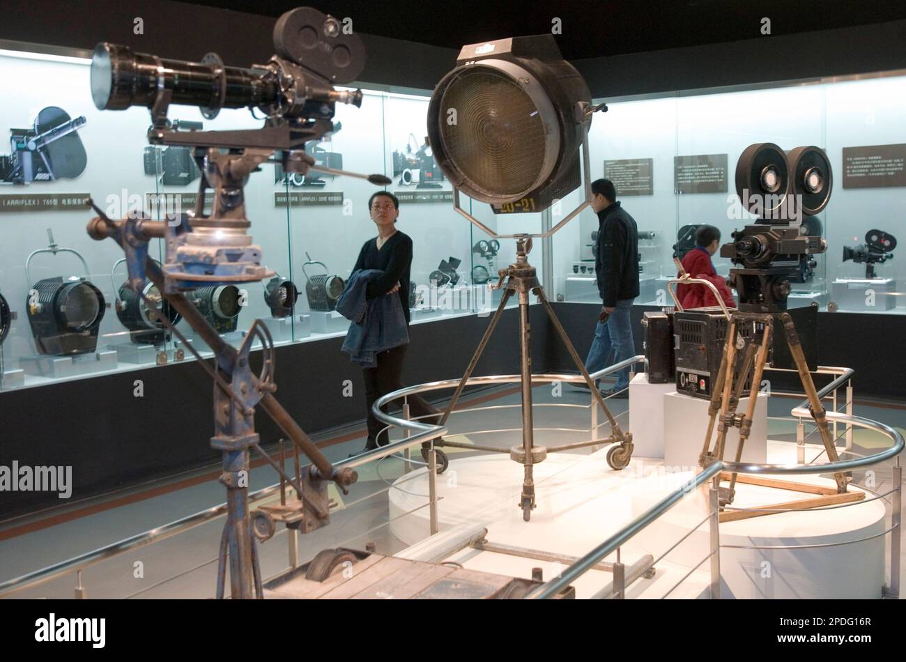 Chinese visitors walk past movie making equipment on display at the ...