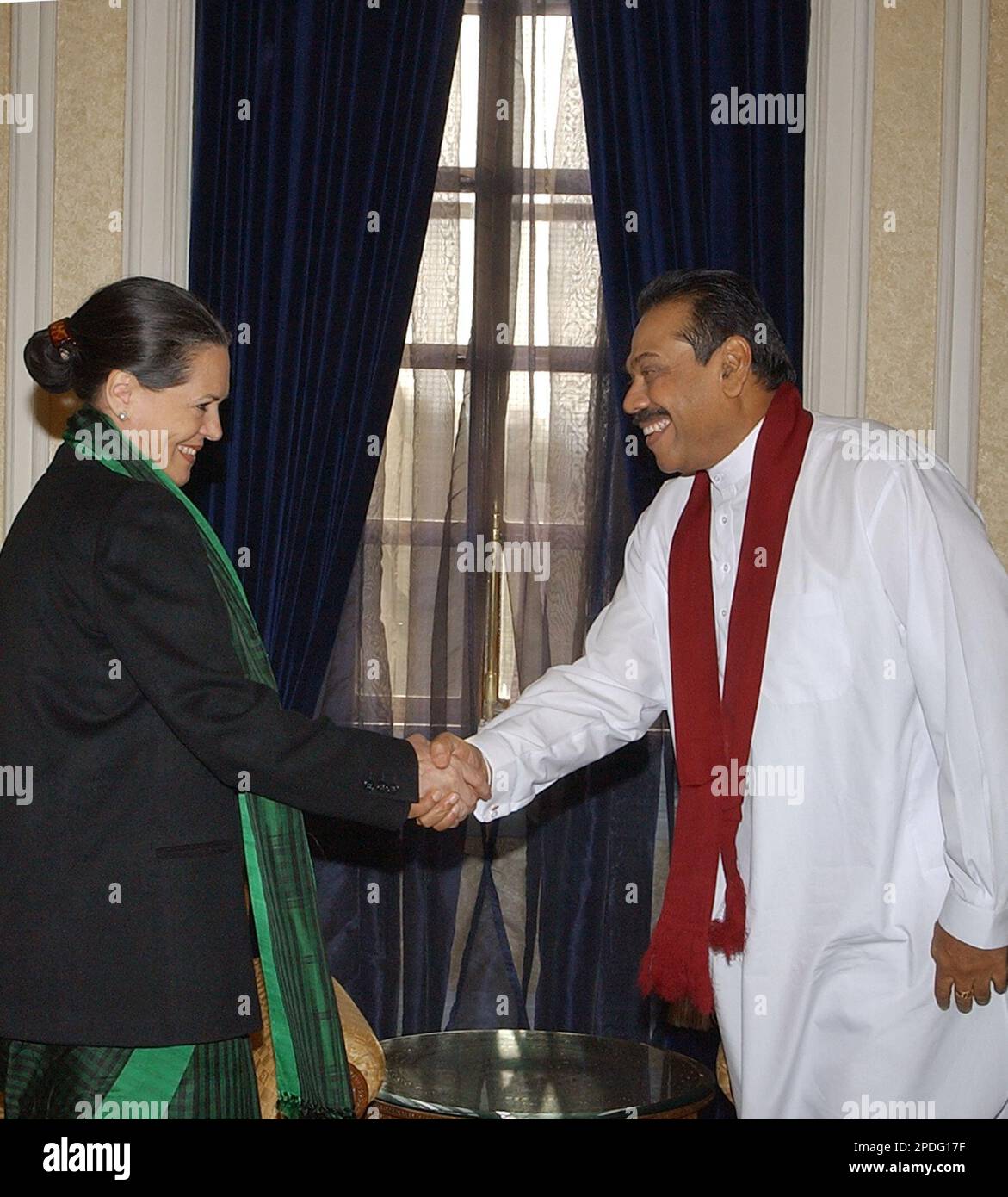 Sri Lankan President Mahinda Rajapakse, right, shakes hands with ...
