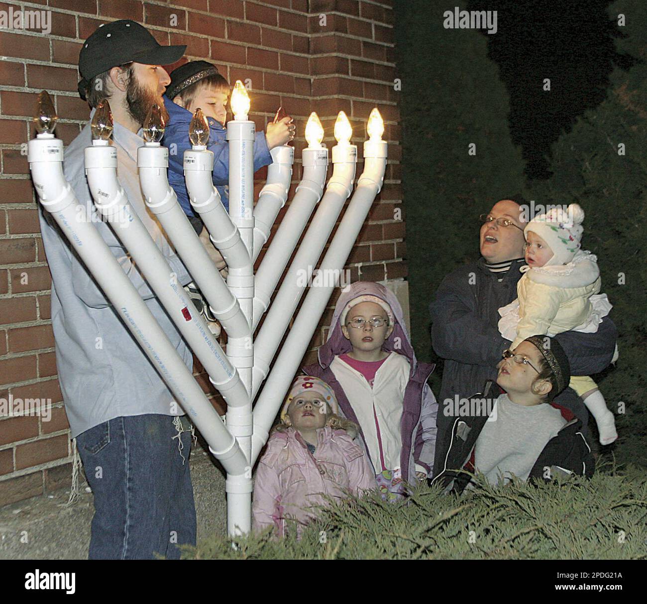 Robert Van Sickle holds his son, Yermiyah, 4, as the boy screws in ...