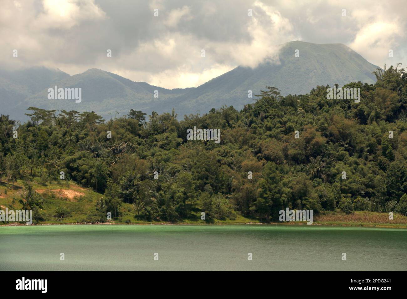 A view of Lake Linow, a volcanic lake, in a background of the twin ...