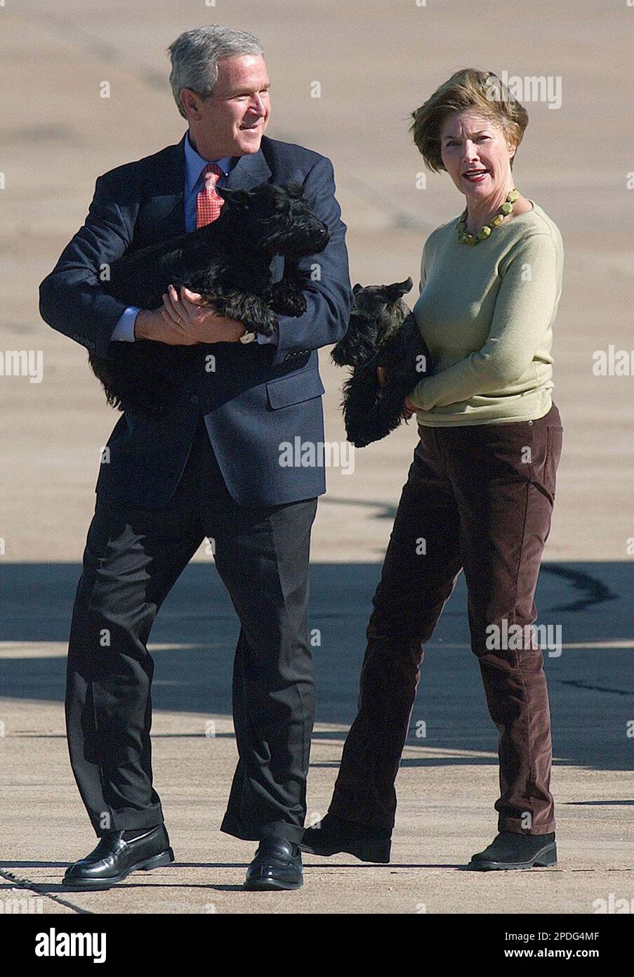 President Bush carries Barney while first lady Laura holds Miss Beazley ...
