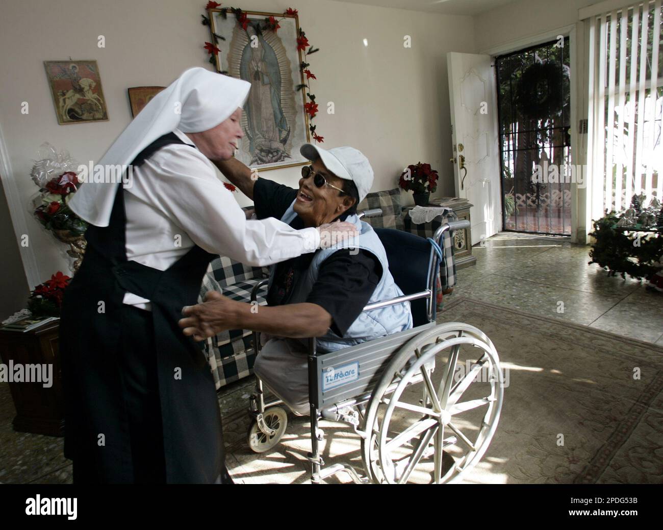Sister Antonia Brenner, 79, embraces Eloisa Mendoza Peregrina, who ...