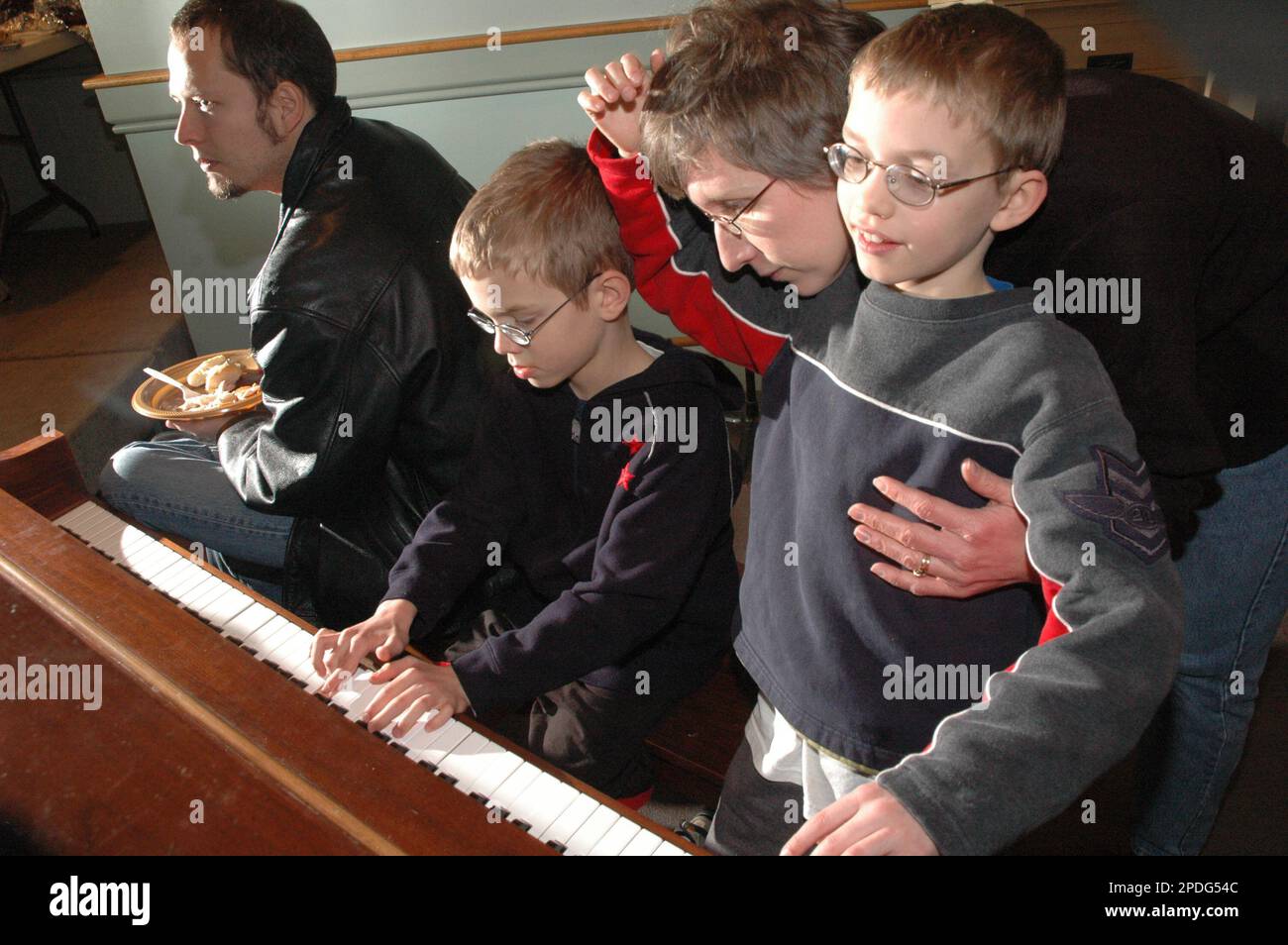 Isaac Ward, 8, second from left, plays "Jingle Bells" for his mother ...