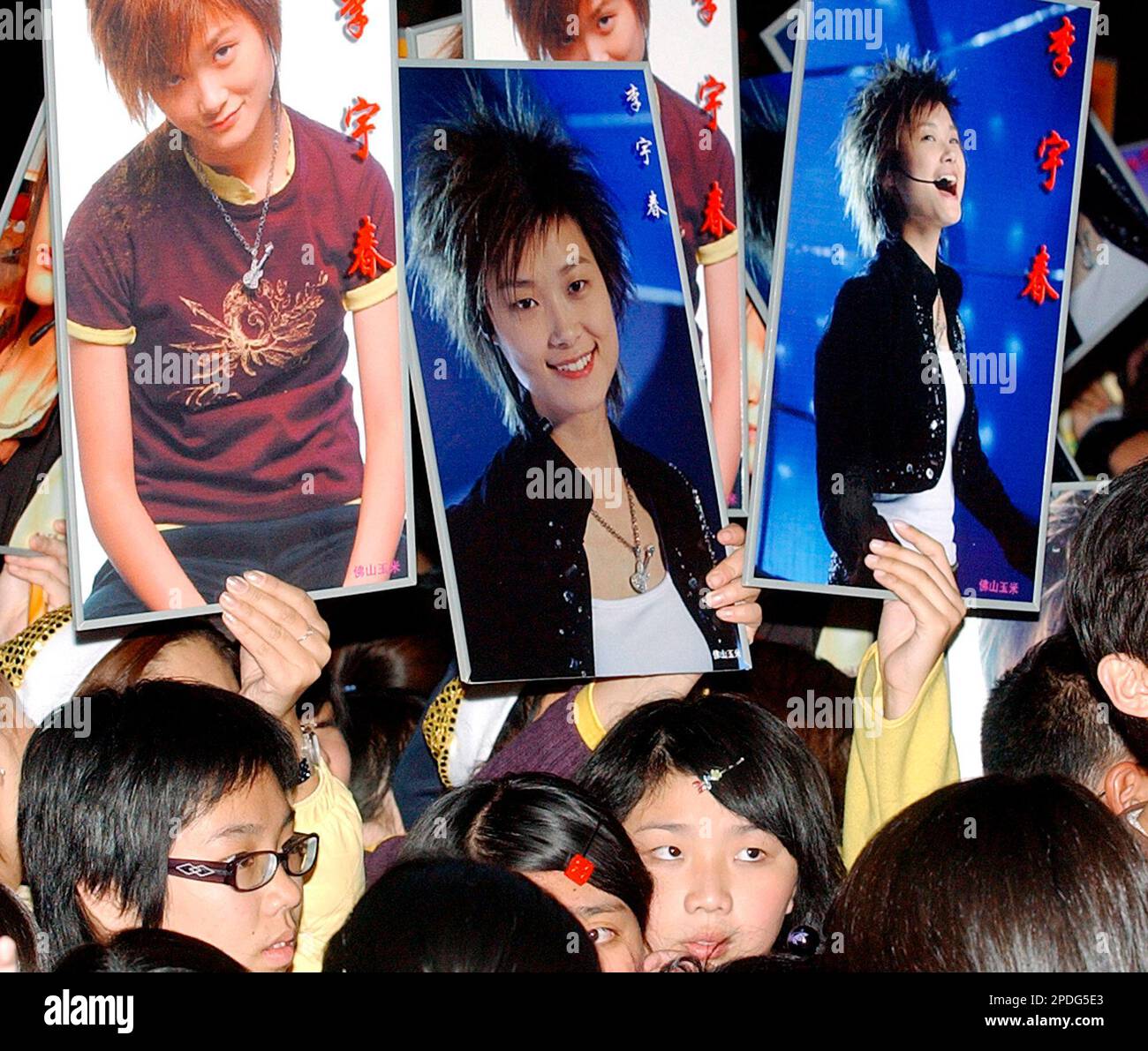 Fans of mainland Chinese singer Li Yu-chun held up her pictures to show ...