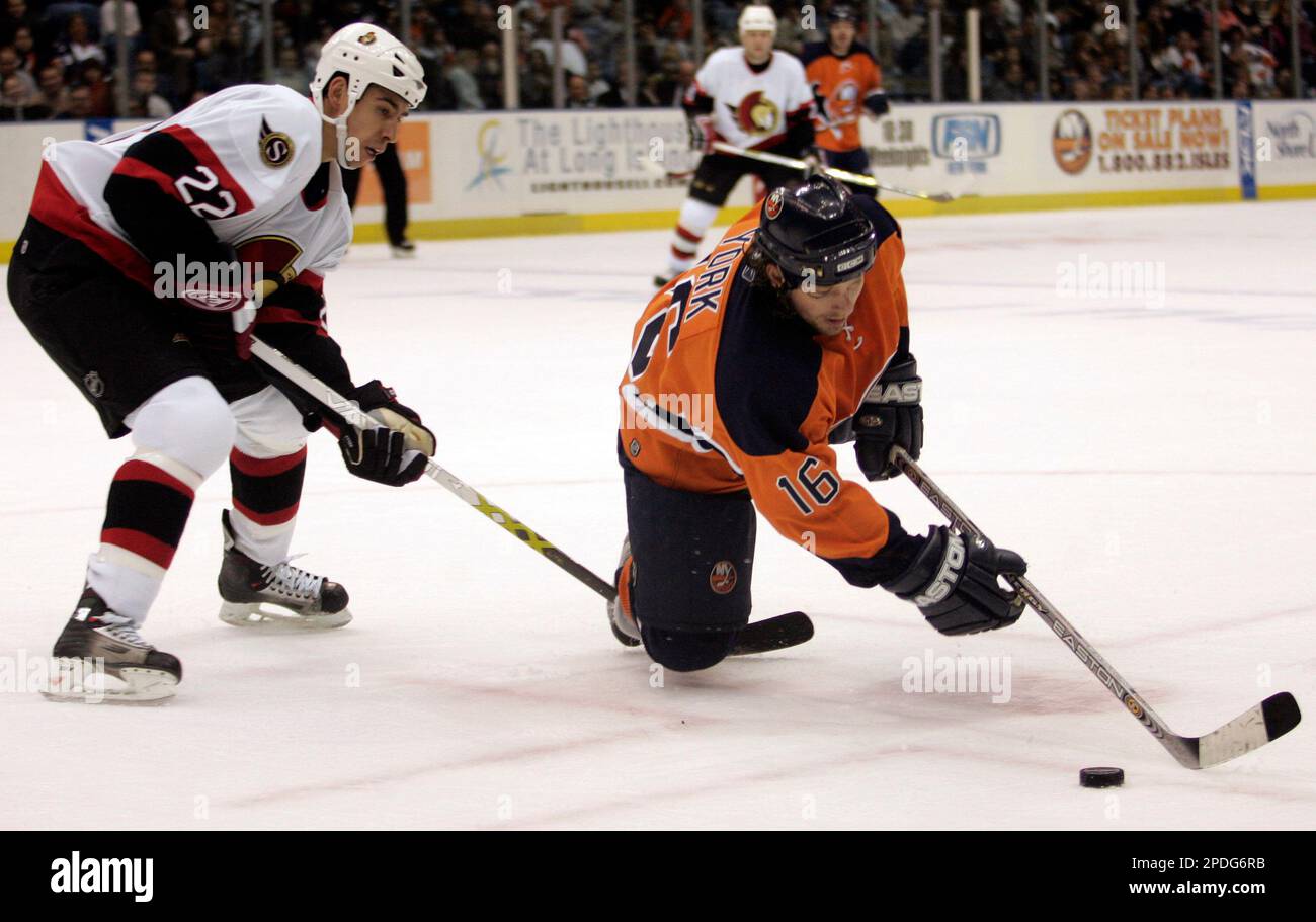 New York Islanders' Mike York reaches for the puck next to Ottawa ...