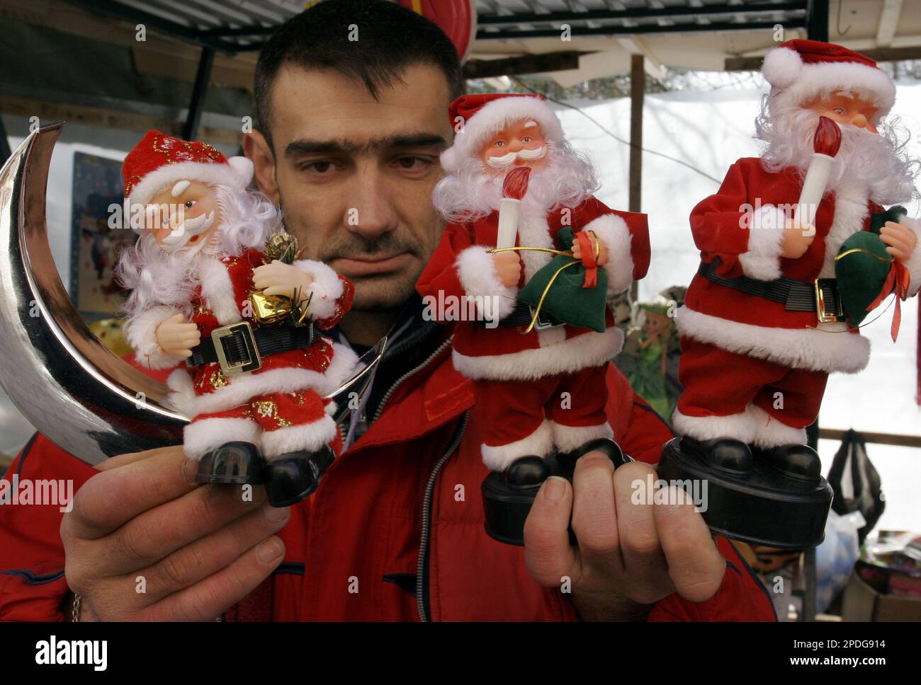 A Sarajevan sells Santa Claus figures at a market in central Sarajevo ...