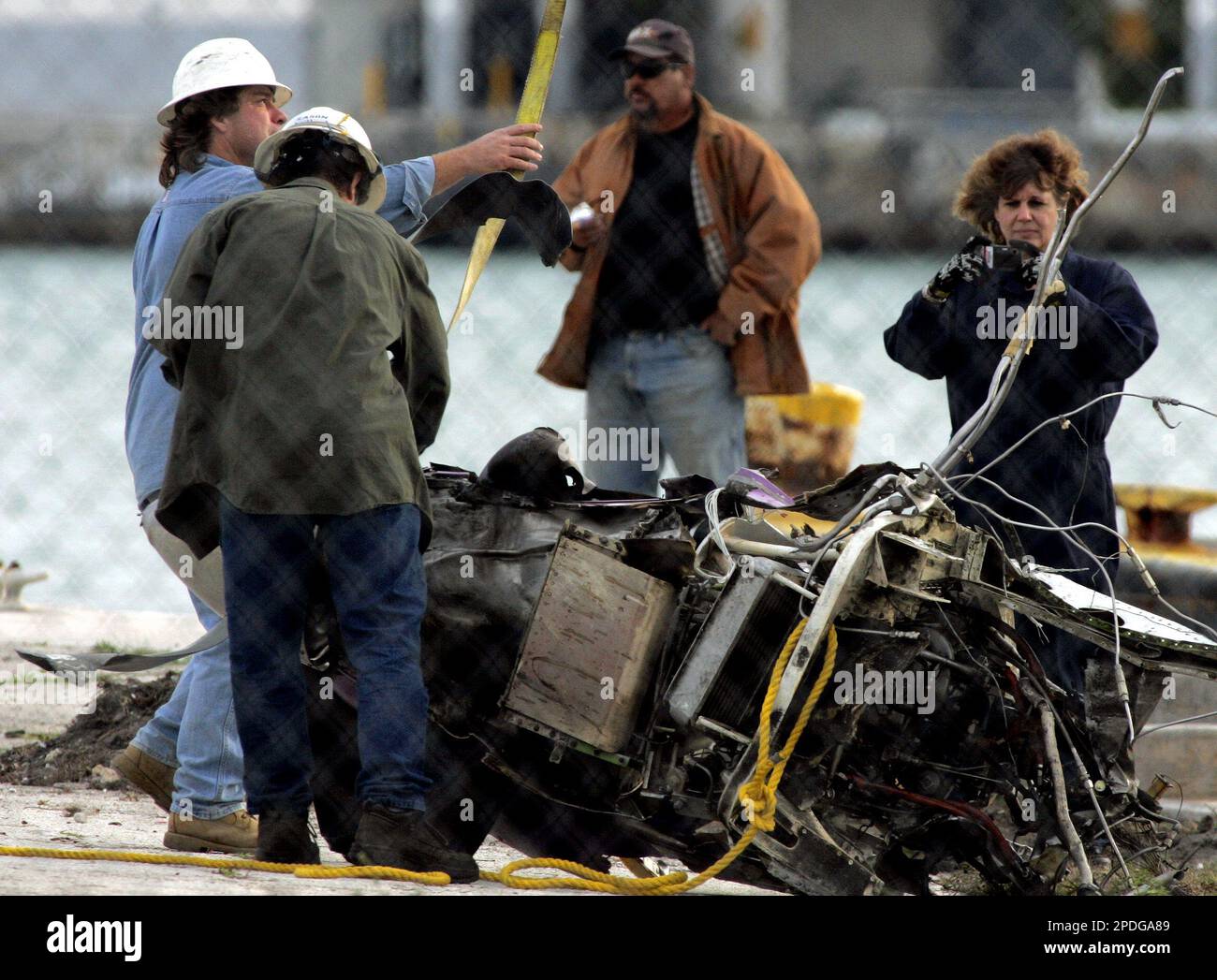 An official photographs the wreckage of a Chalk's Ocean Airways plane ...