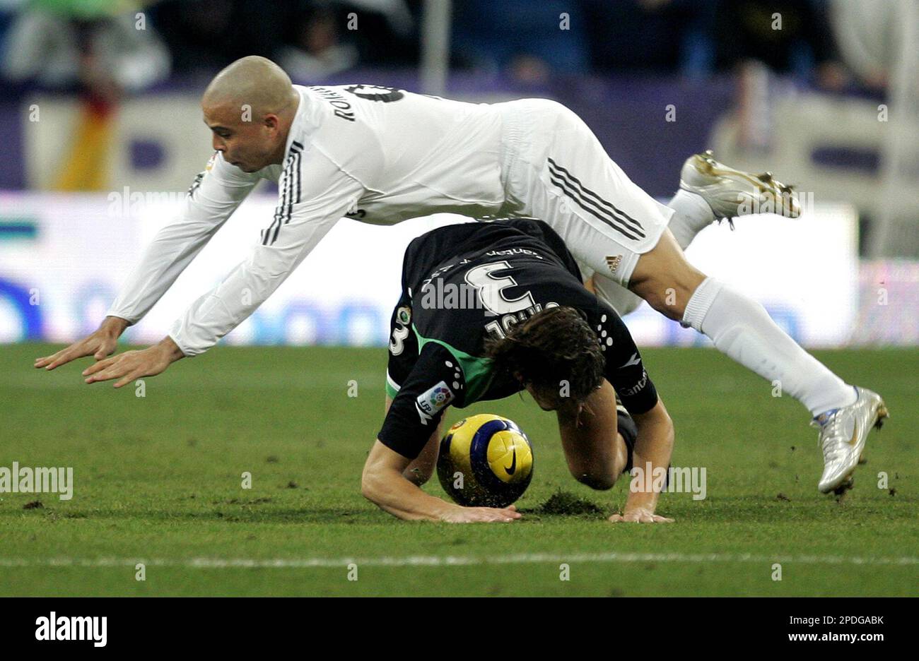 Real Madrid's Brazilian player Ronaldo, top, jumps over Racing ...