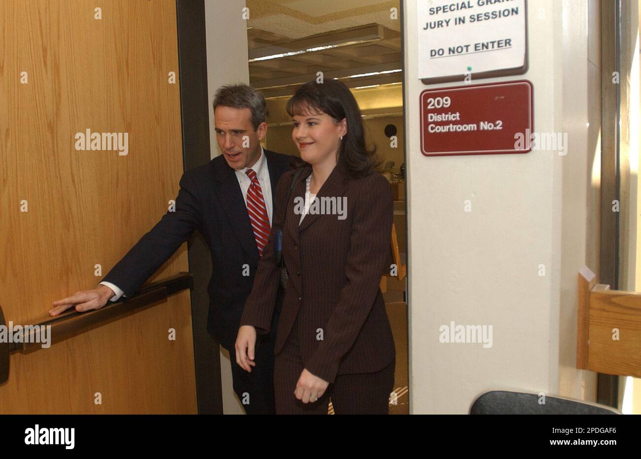 Prosecutor Scott Crawford-Sutherland, left, opens the door for Crystal ...