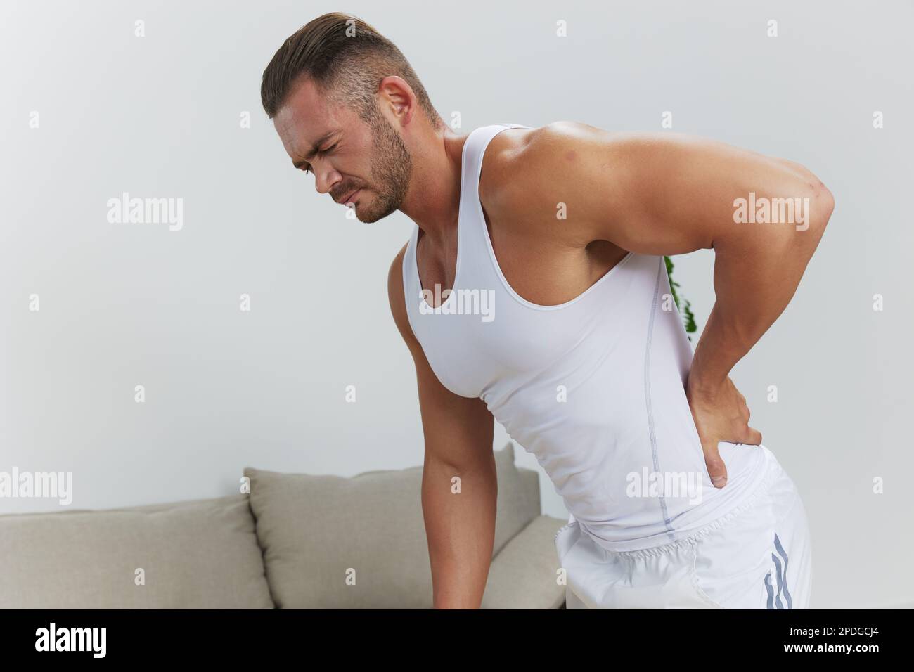 Man sports back pain, spine problems from working out at home, pumped ...