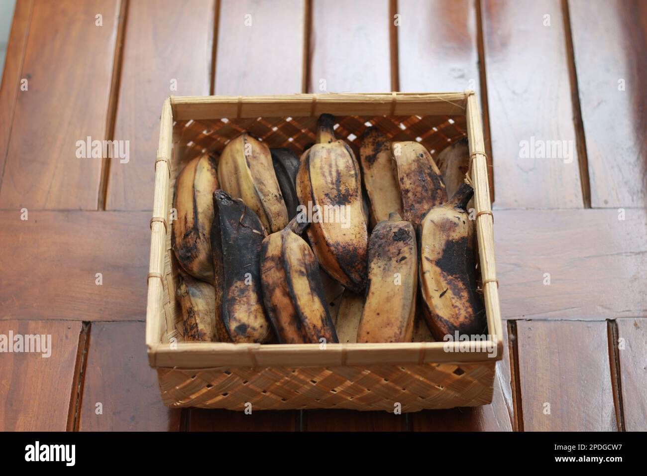a close up of steamed bananas served on a woven bamboo container Stock ...