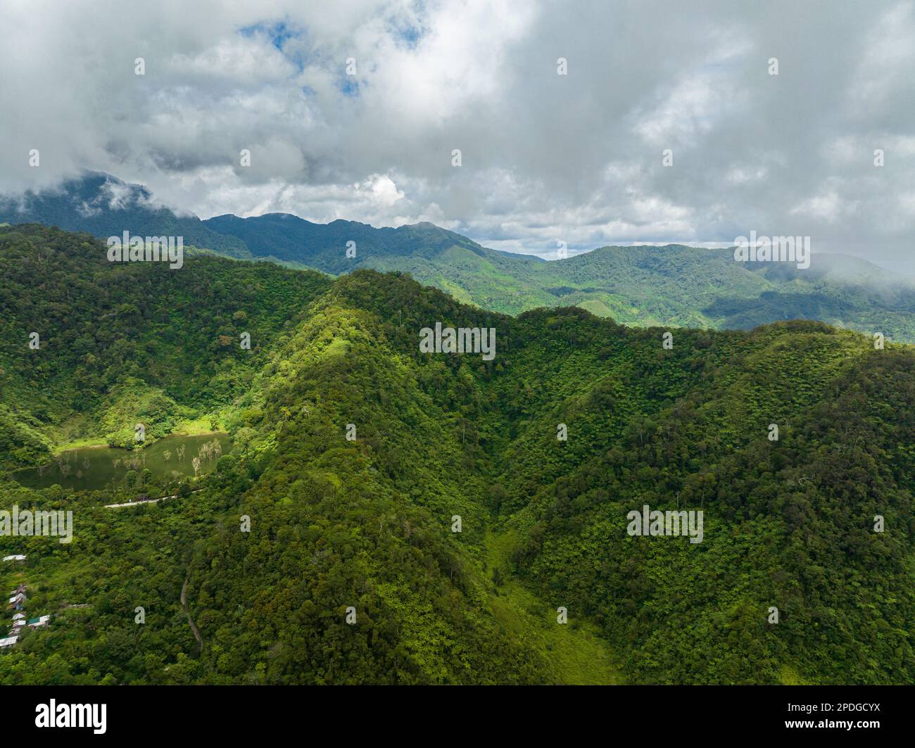 Aerial view of mountains and hills with green forest and clouds. Negros ...