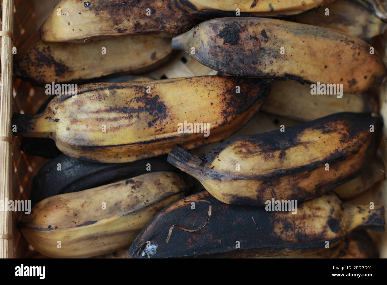 a close up of steamed bananas served on a woven bamboo container Stock ...
