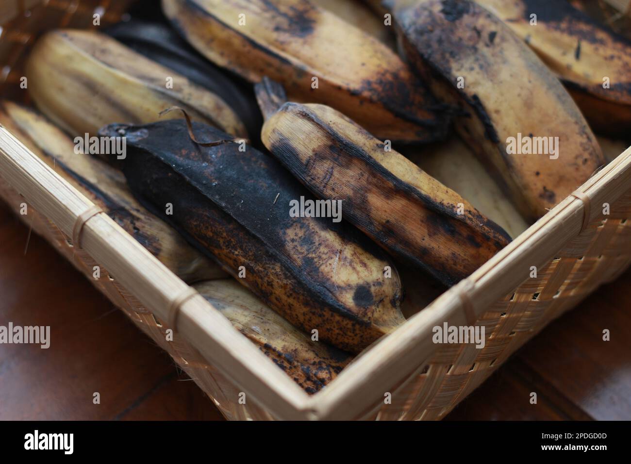 a close up of steamed bananas served on a woven bamboo container Stock ...