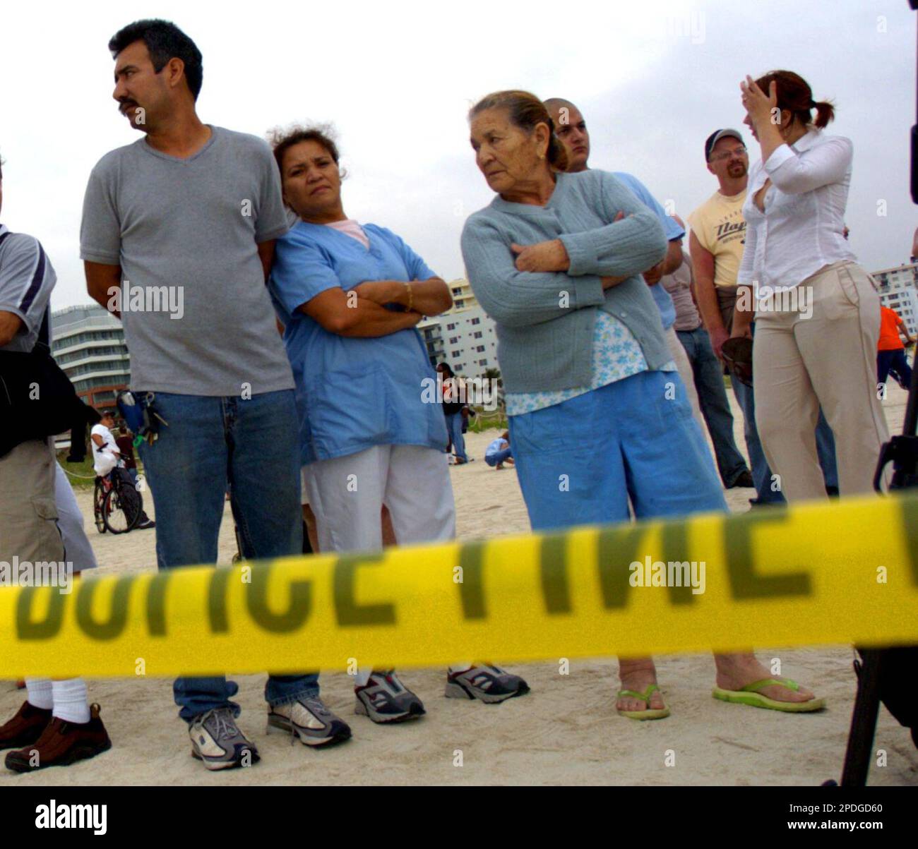 Onlookers stand behind crime scene tape near where a Chalk's Ocean ...
