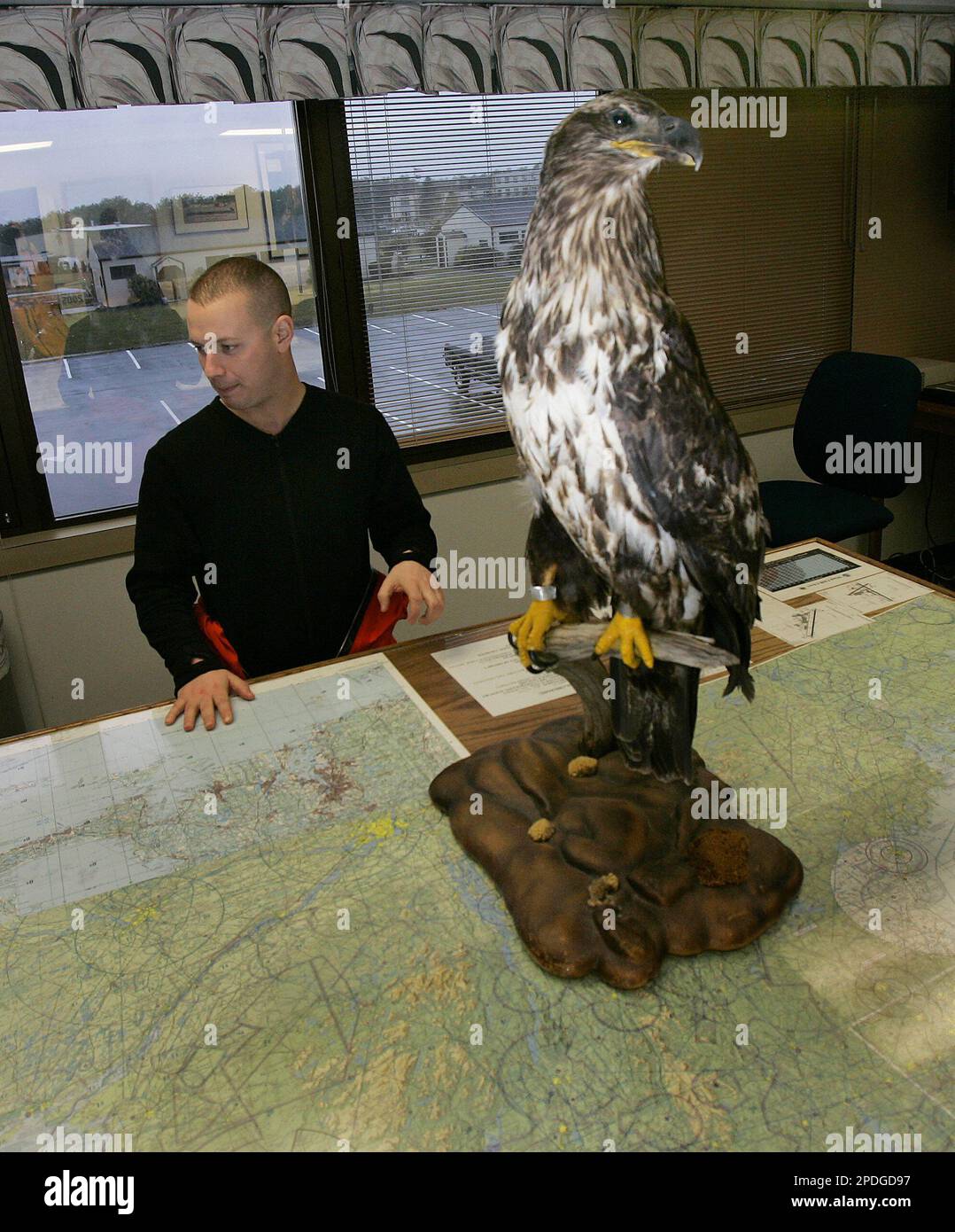 U.S. Coast Guard pilot Lt. Sean Krueger speaks while a stuffed falcon ...