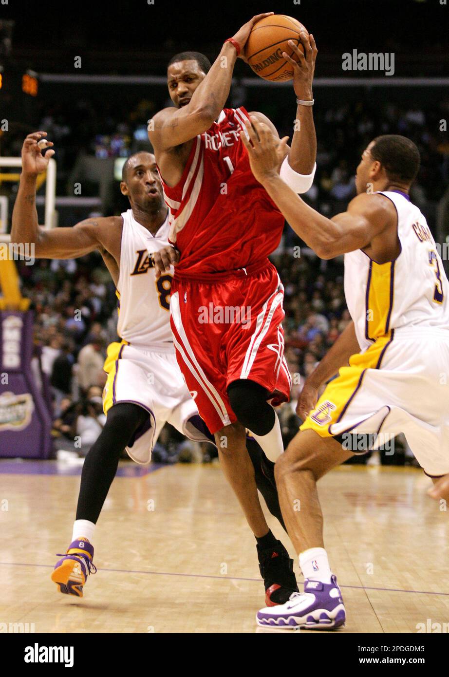Houston Rockets' Tracy McGrady, center, tries to jump through the ...