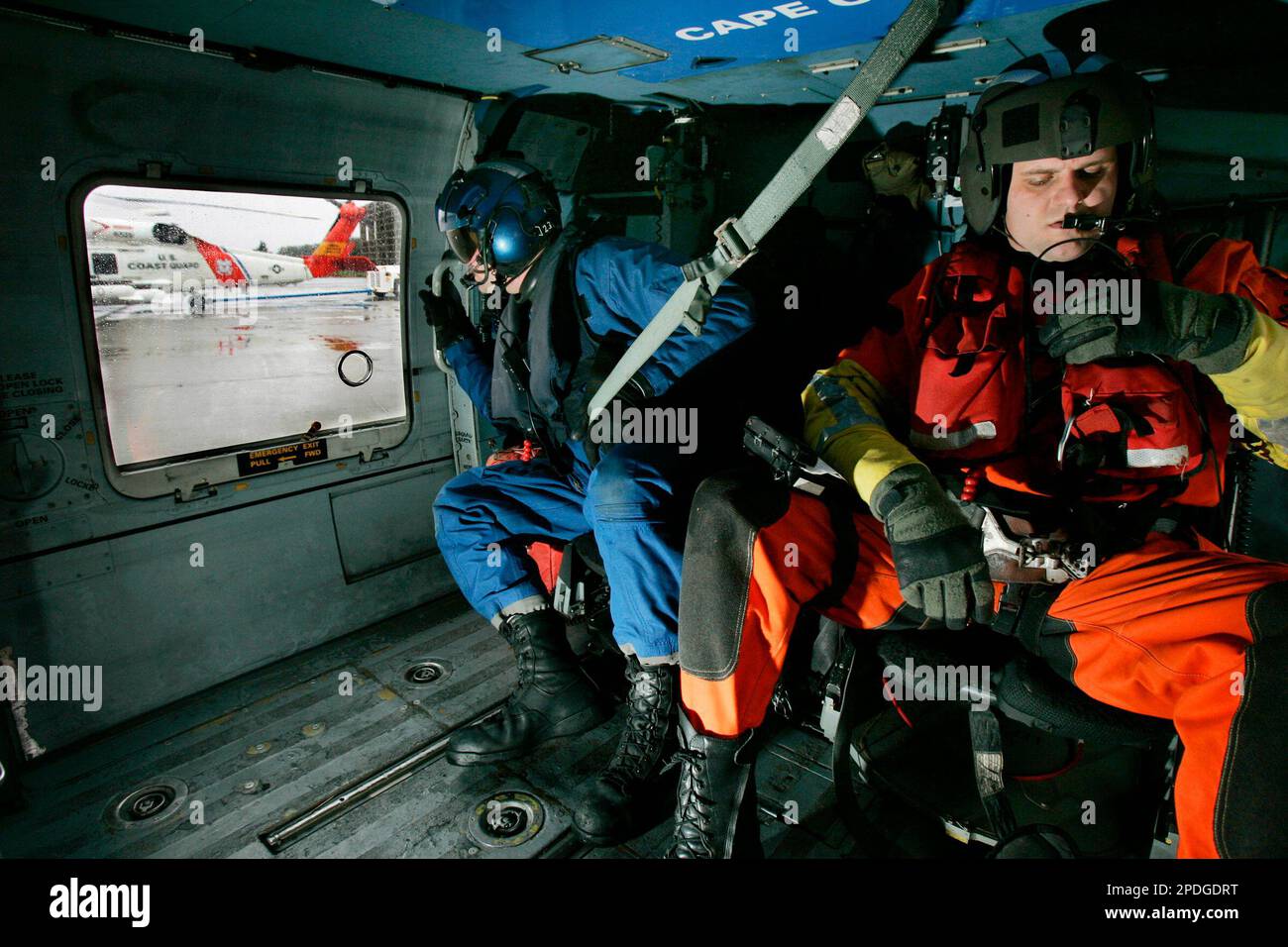 Flight mechanic Petty Officer Second Class Corey Mason, left, and ...