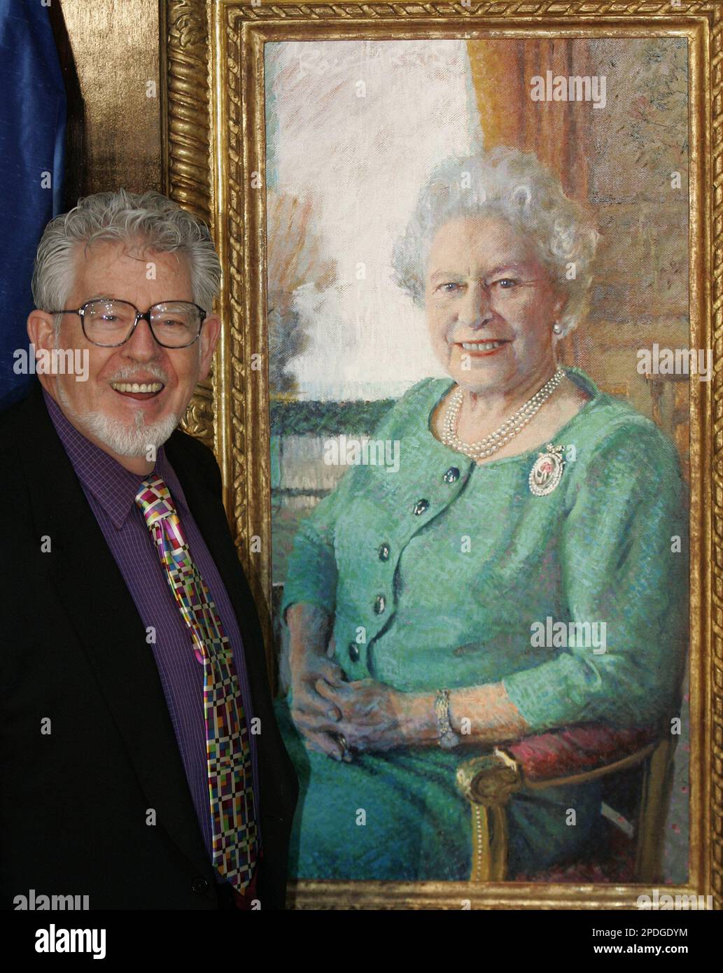 Artist Rolf Harris stands with his portrait of Britain's Queen ...